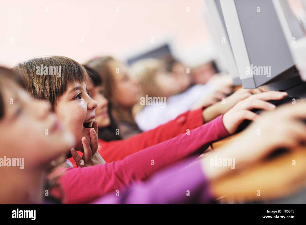 it education with children group in school at computer science class ...