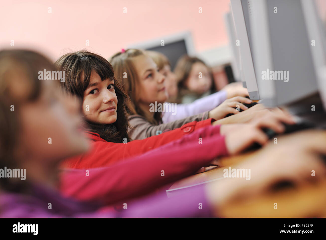 it education with children group in school at computer science class ...