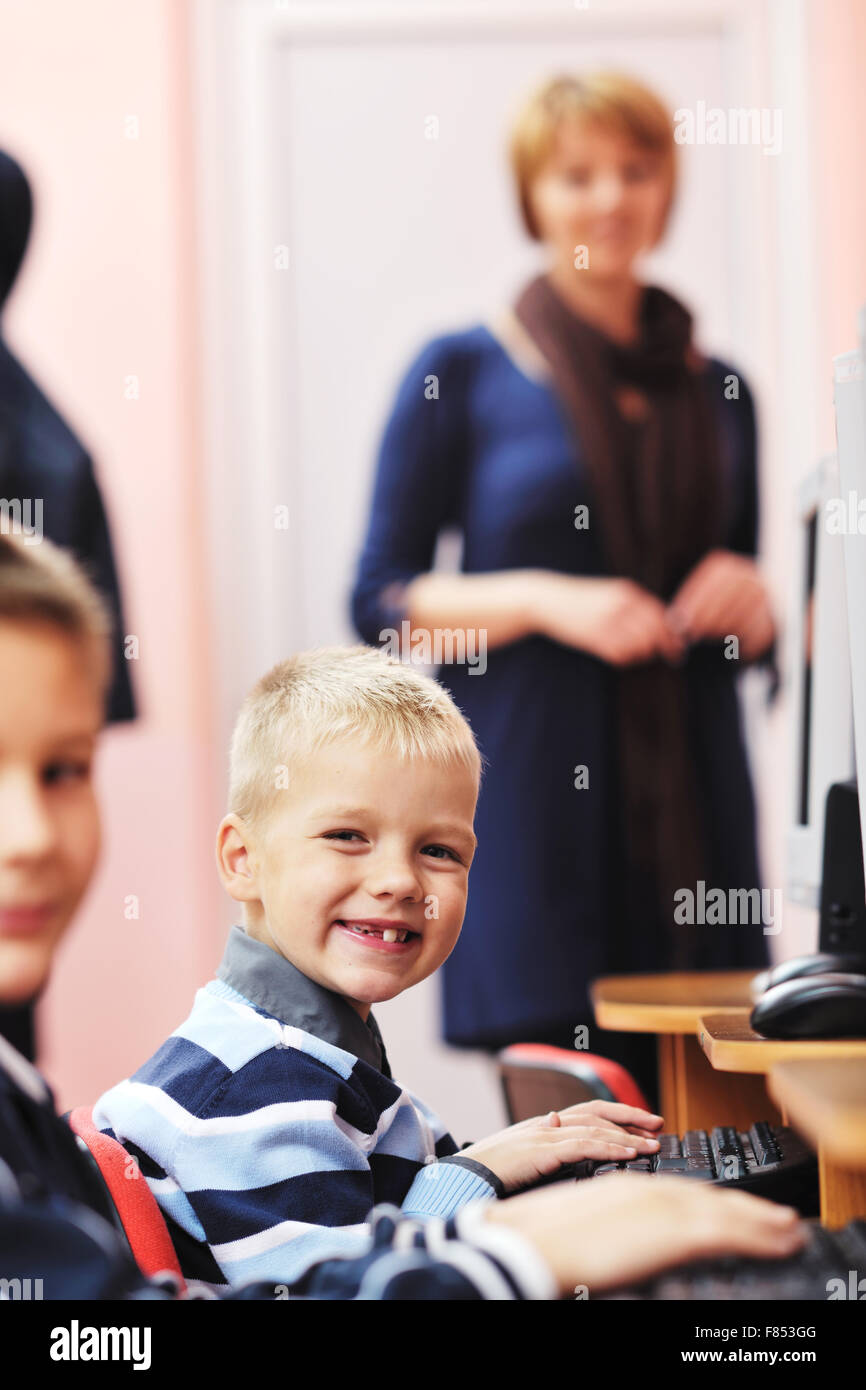 it education with children group in school at computer science class ...