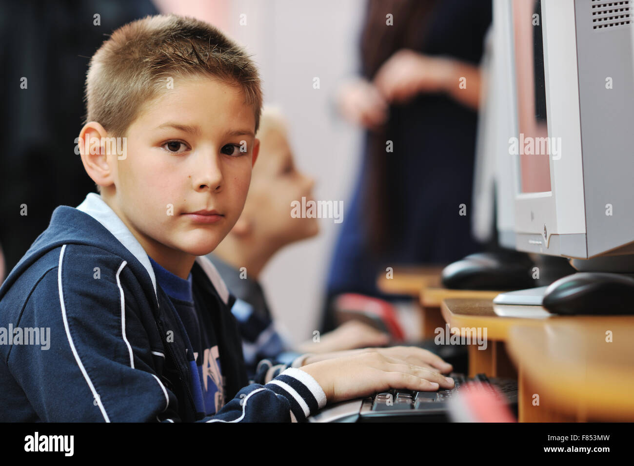 it education with children group in school at computer science class ...