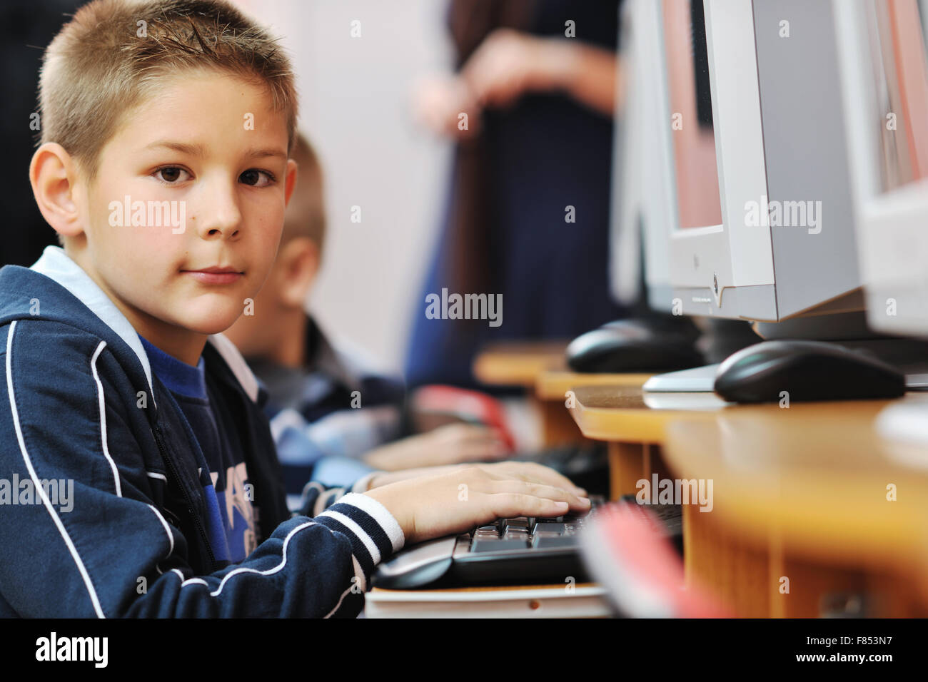 it education with children group in school at computer science class ...