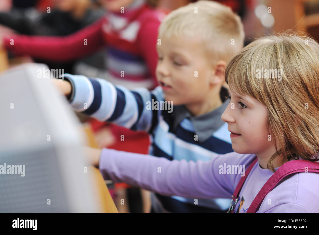 it education with children group in school at computer science class ...