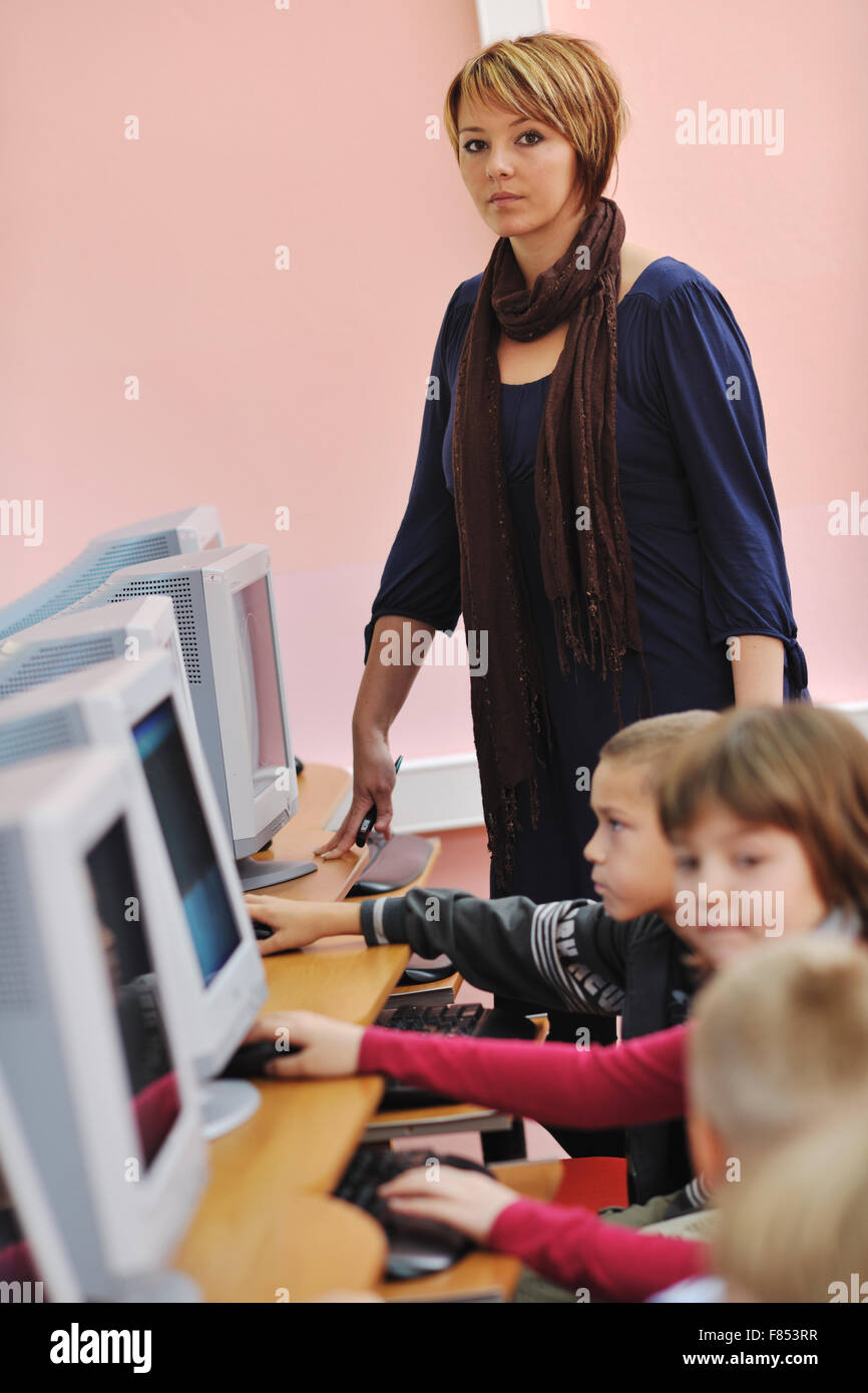 it education with children group in school at computer science class ...