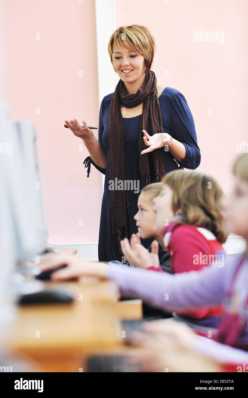 it education with children group in school at computer science class ...