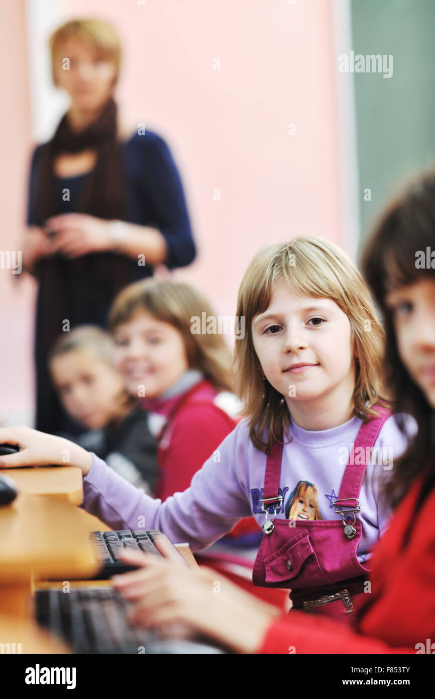 it education with children group in school at computer science class ...