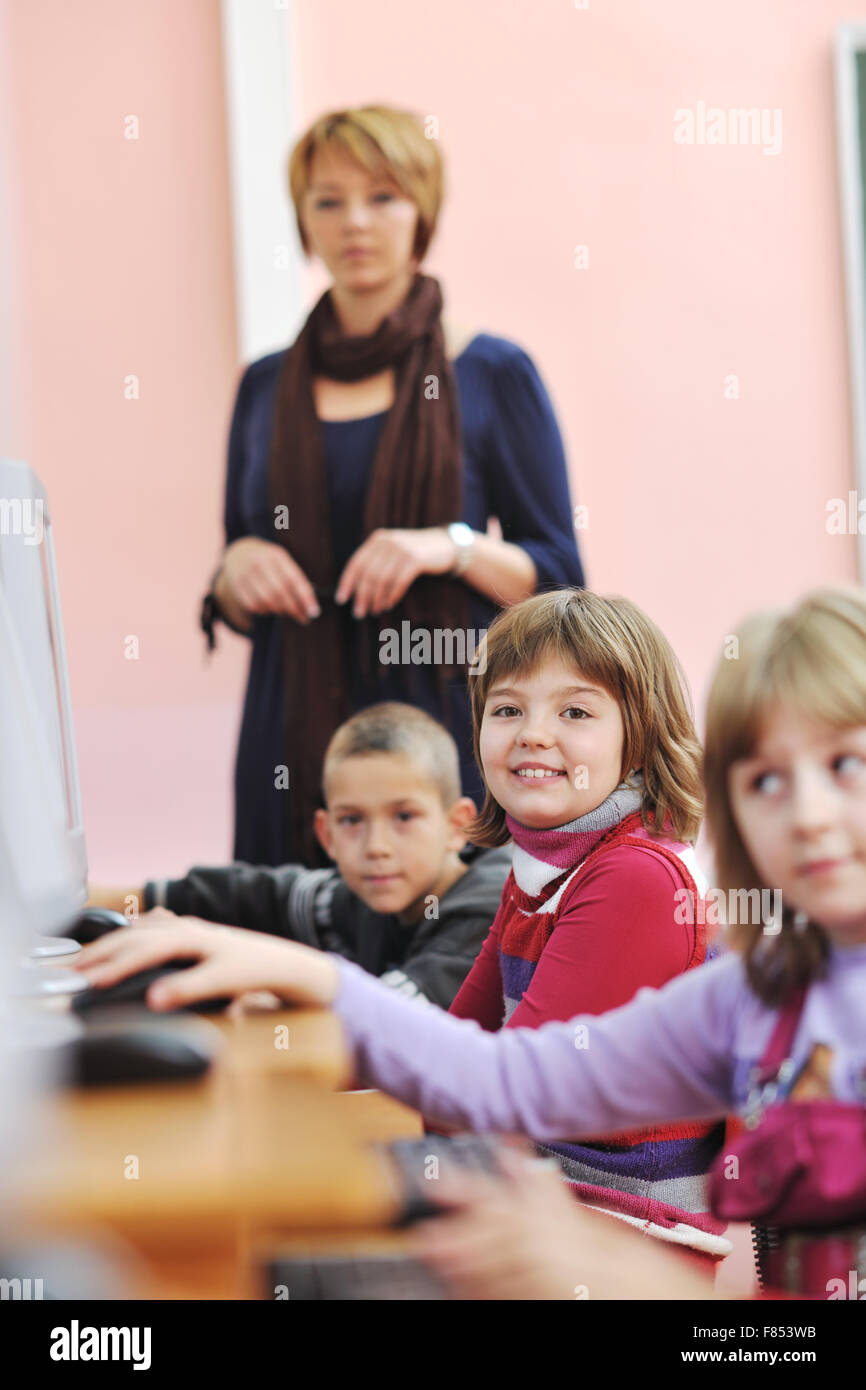 it education with children group in school at computer science class ...