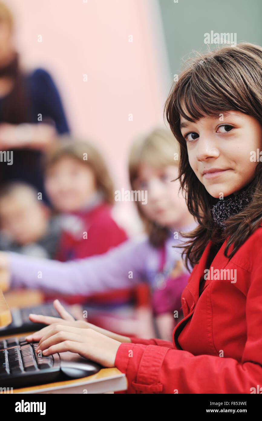 it education with children group in school at computer science class ...