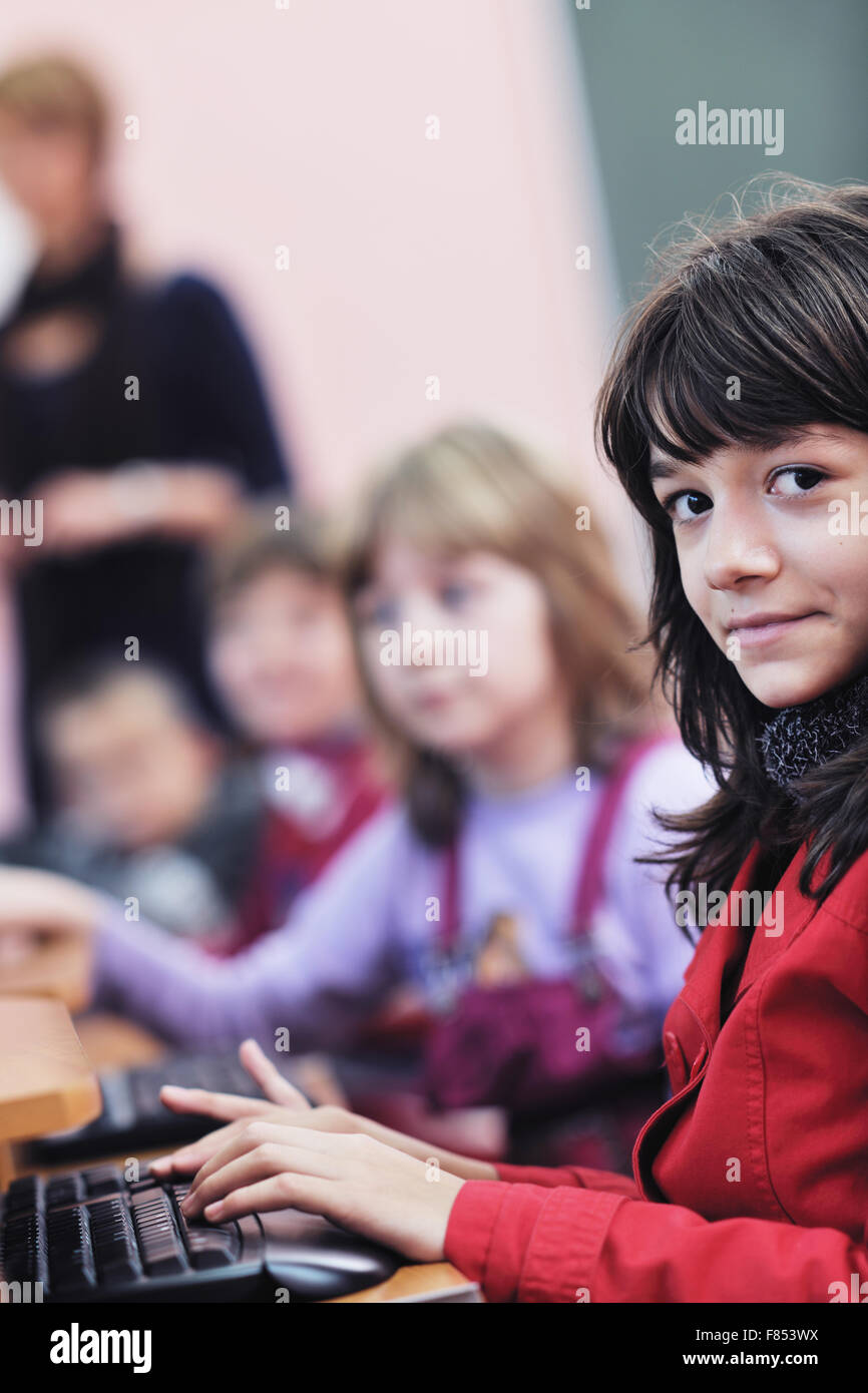 it education with children group in school at computer science class ...