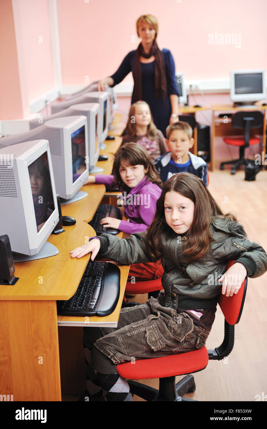 it education with children group in school at computer science class ...