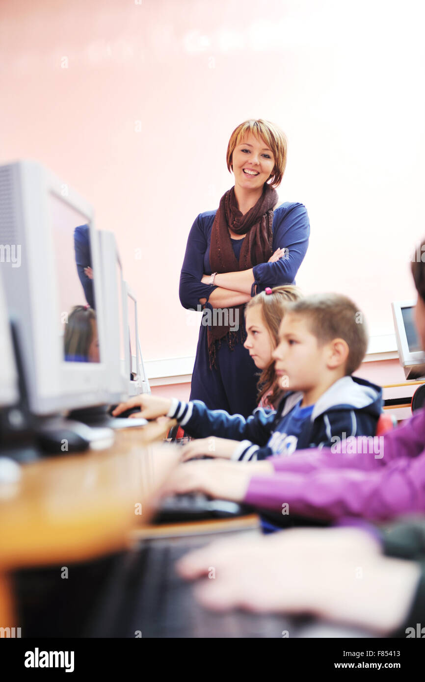 it education with children group in school at computer science class ...