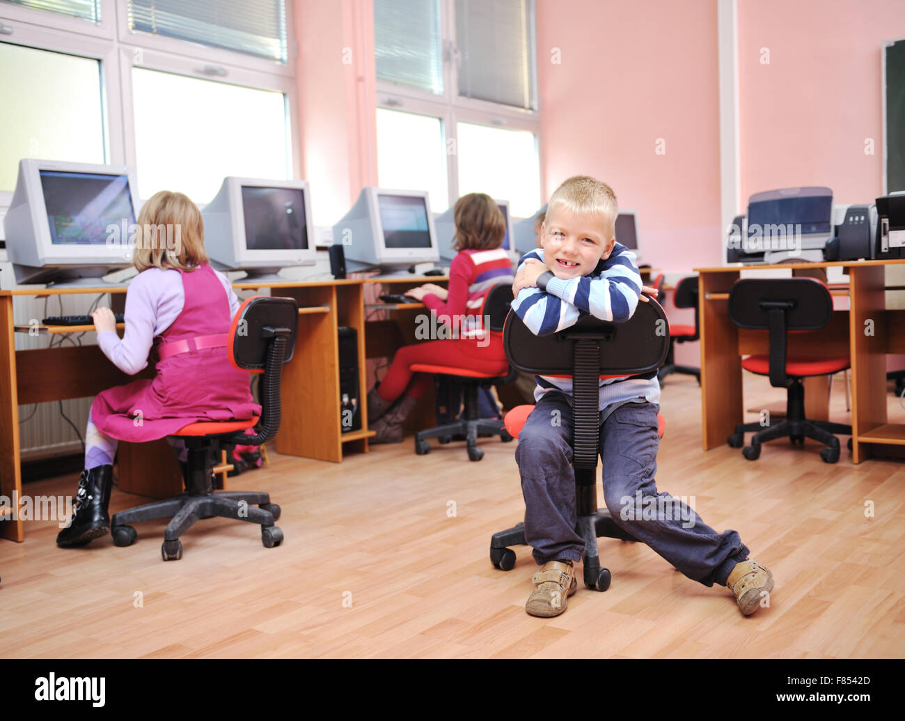 it education with children group in school at computer science class ...