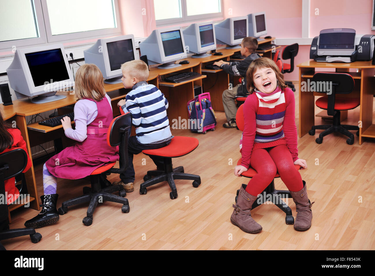it education with children group in school at computer science class ...