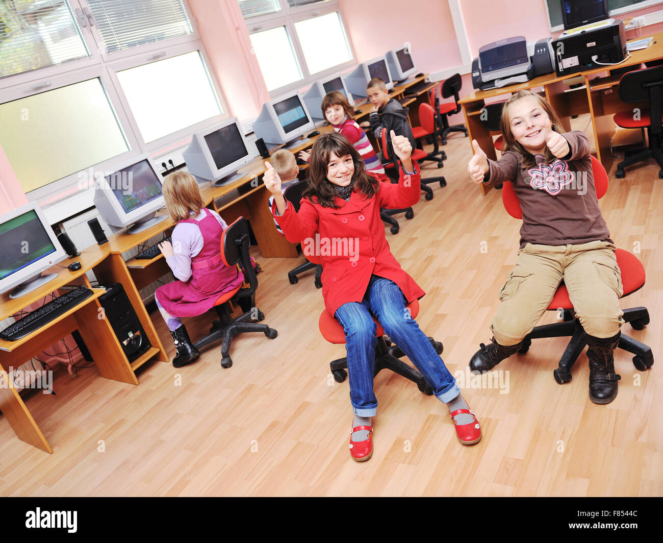 it education with children group in school at computer science class ...