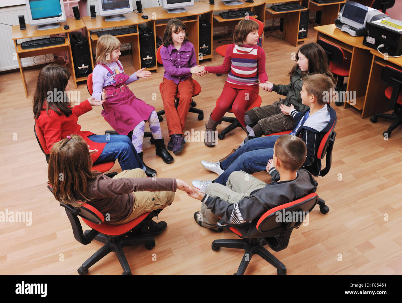 it education with children group in school at computer science class ...