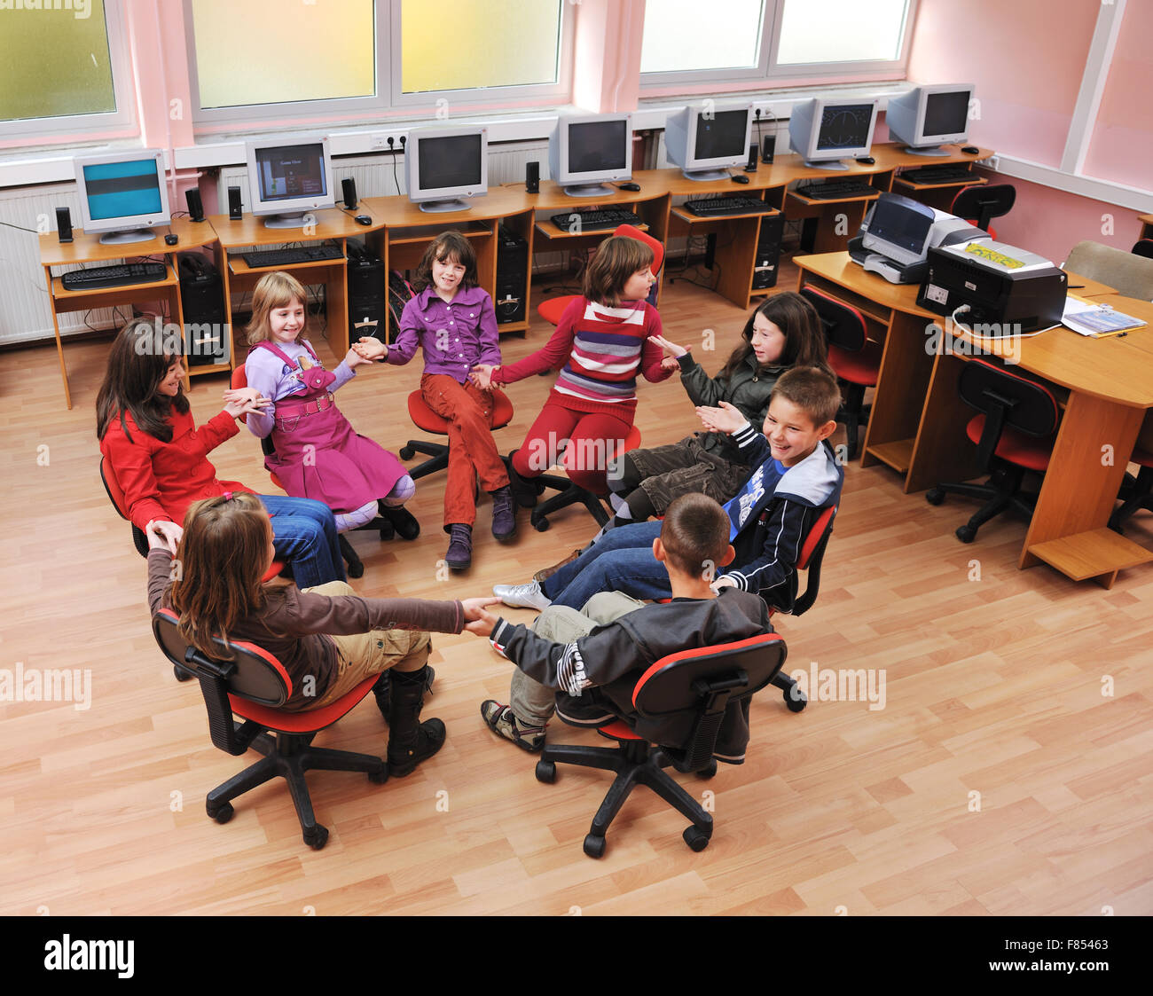 it education with children group in school at computer science class ...