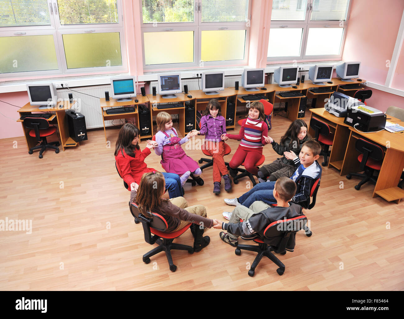 it education with children group in school at computer science class ...