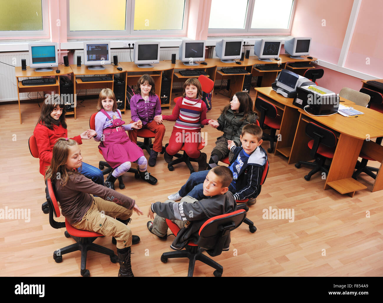it education with children group in school at computer science class ...