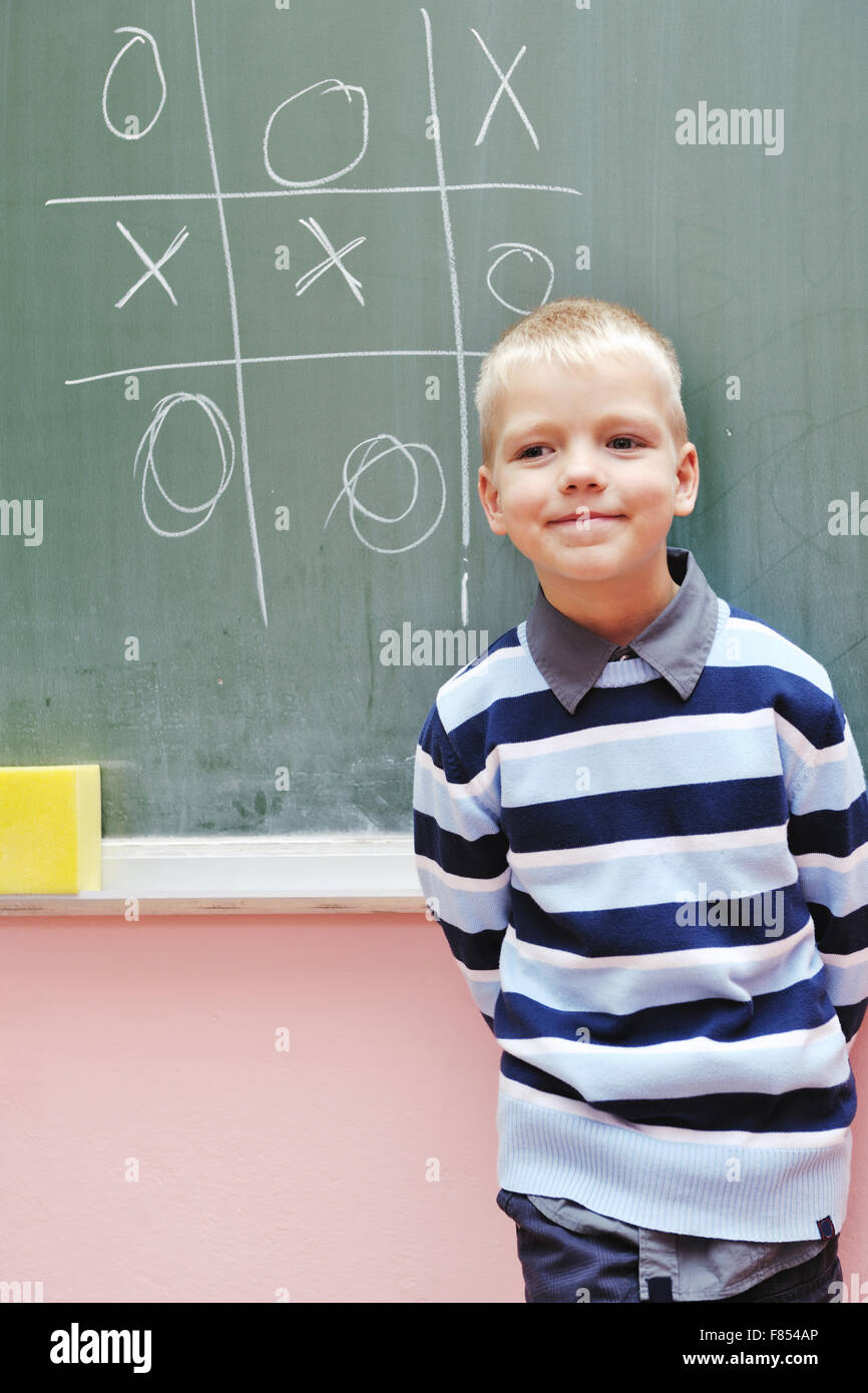 happy young boy at first grade math classes solving problems and ...