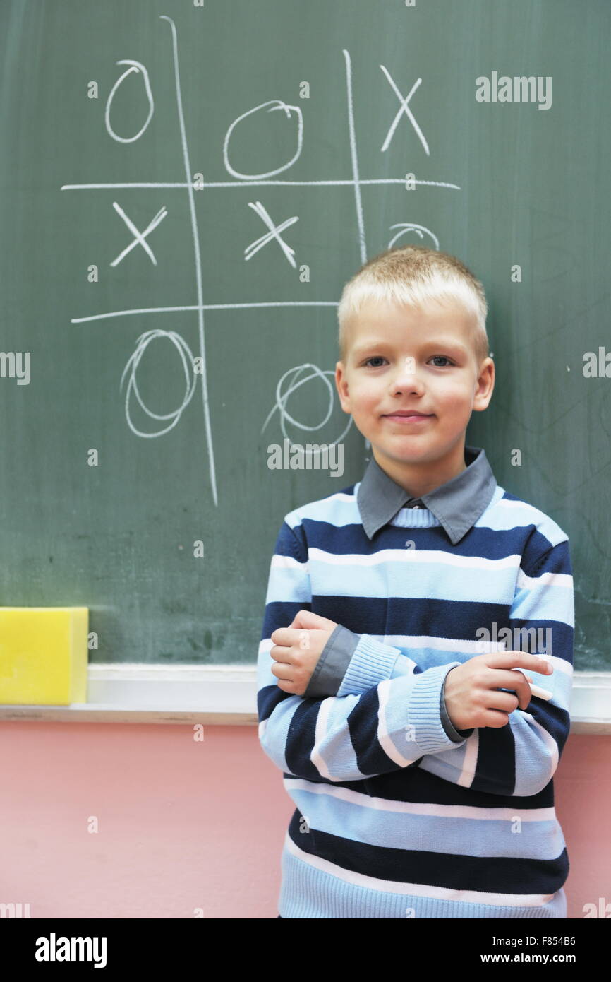 happy young boy at first grade math classes solving problems and ...
