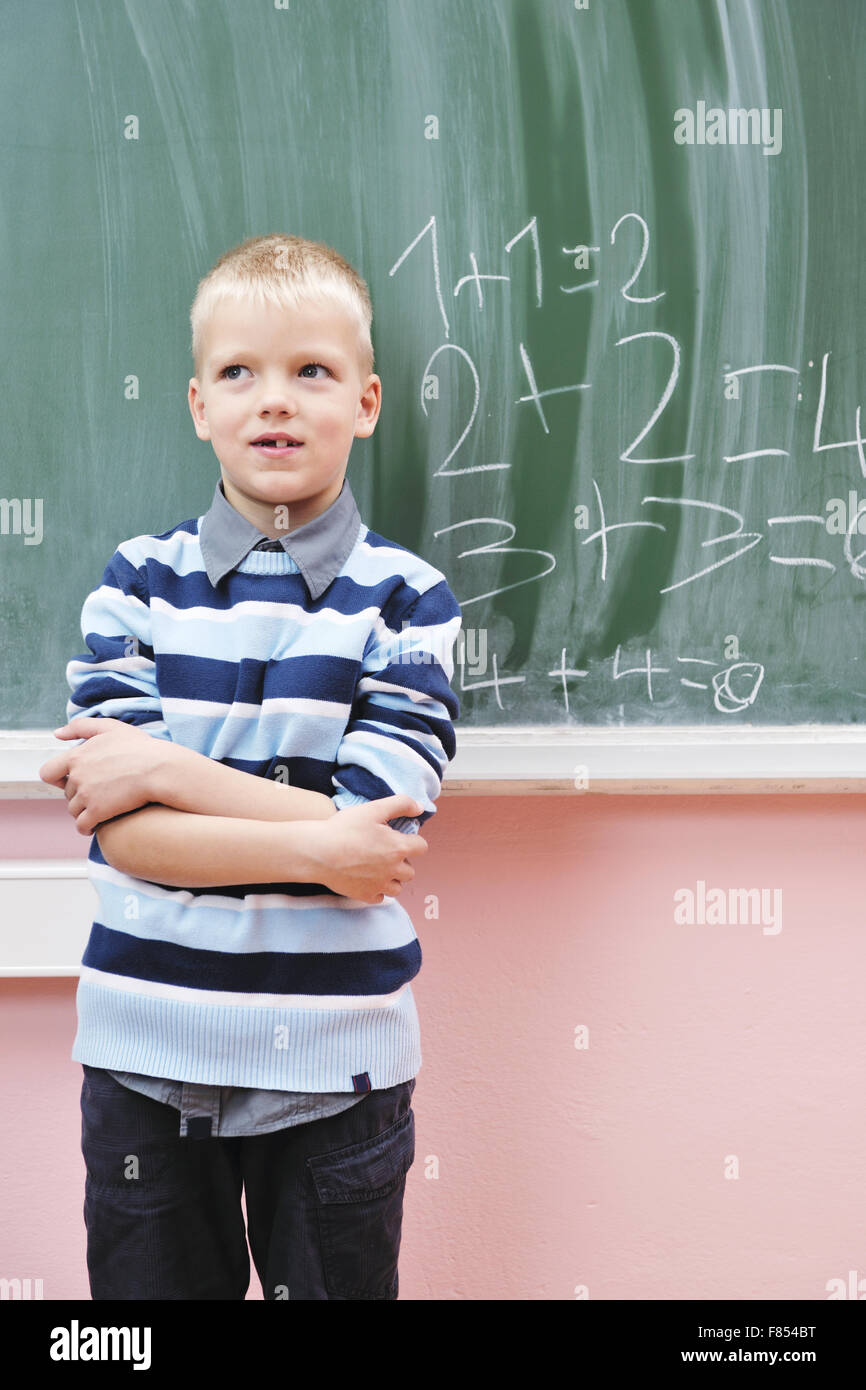 happy young boy at first grade math classes solving problems and ...