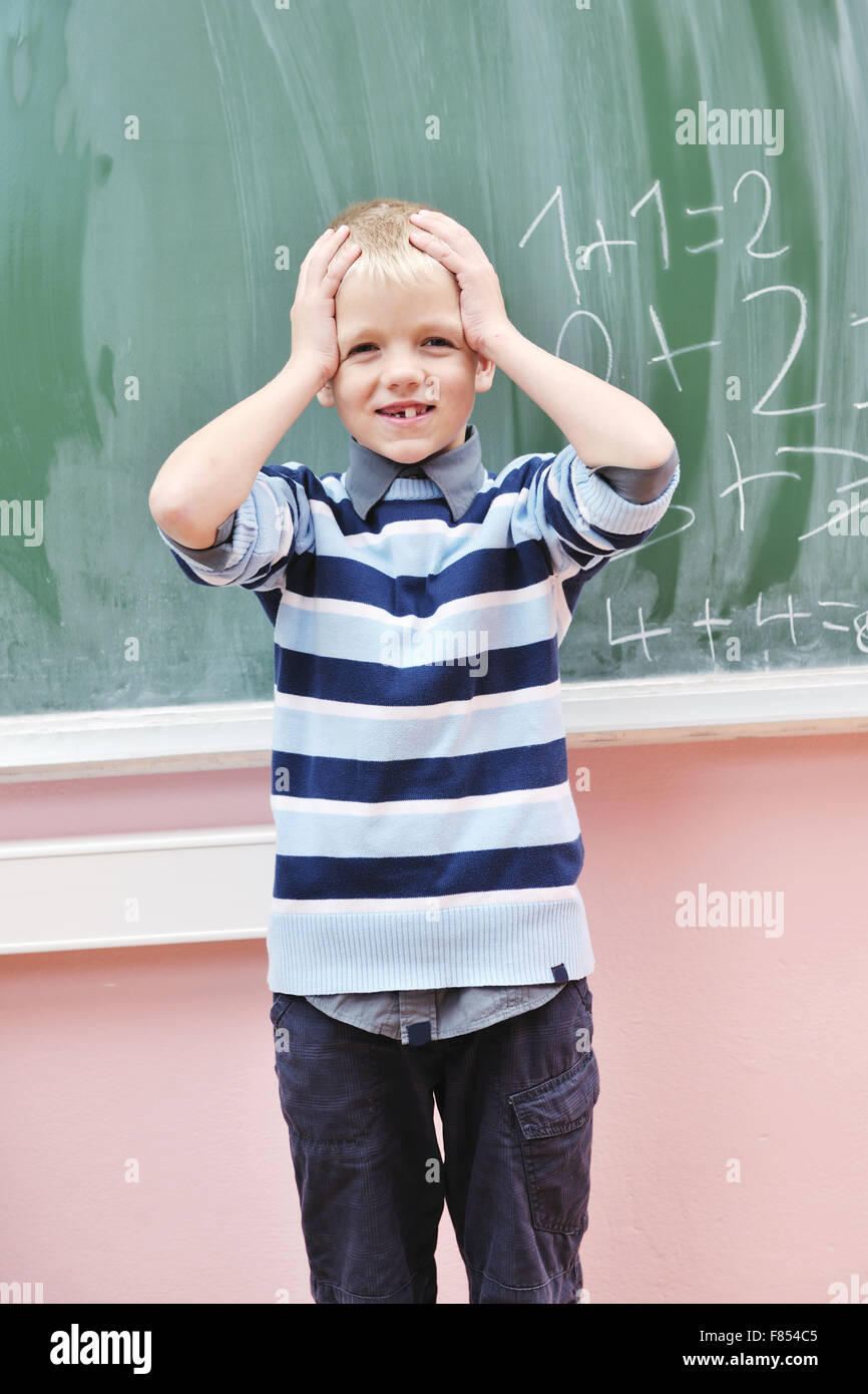 happy young boy at first grade math classes solving problems and ...