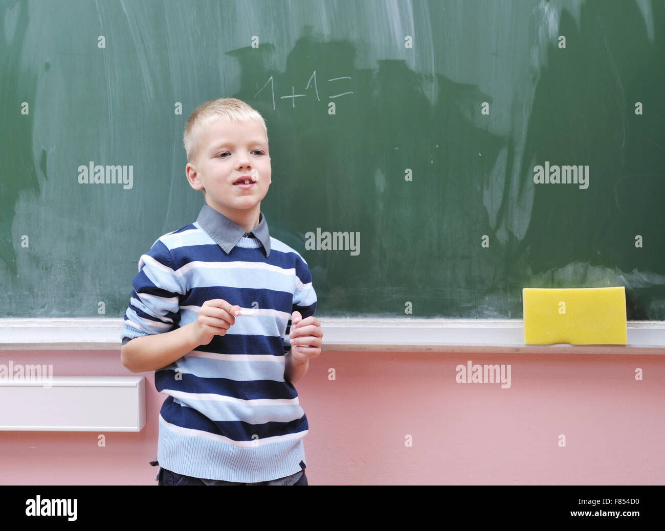 happy young boy at first grade math classes solving problems and ...