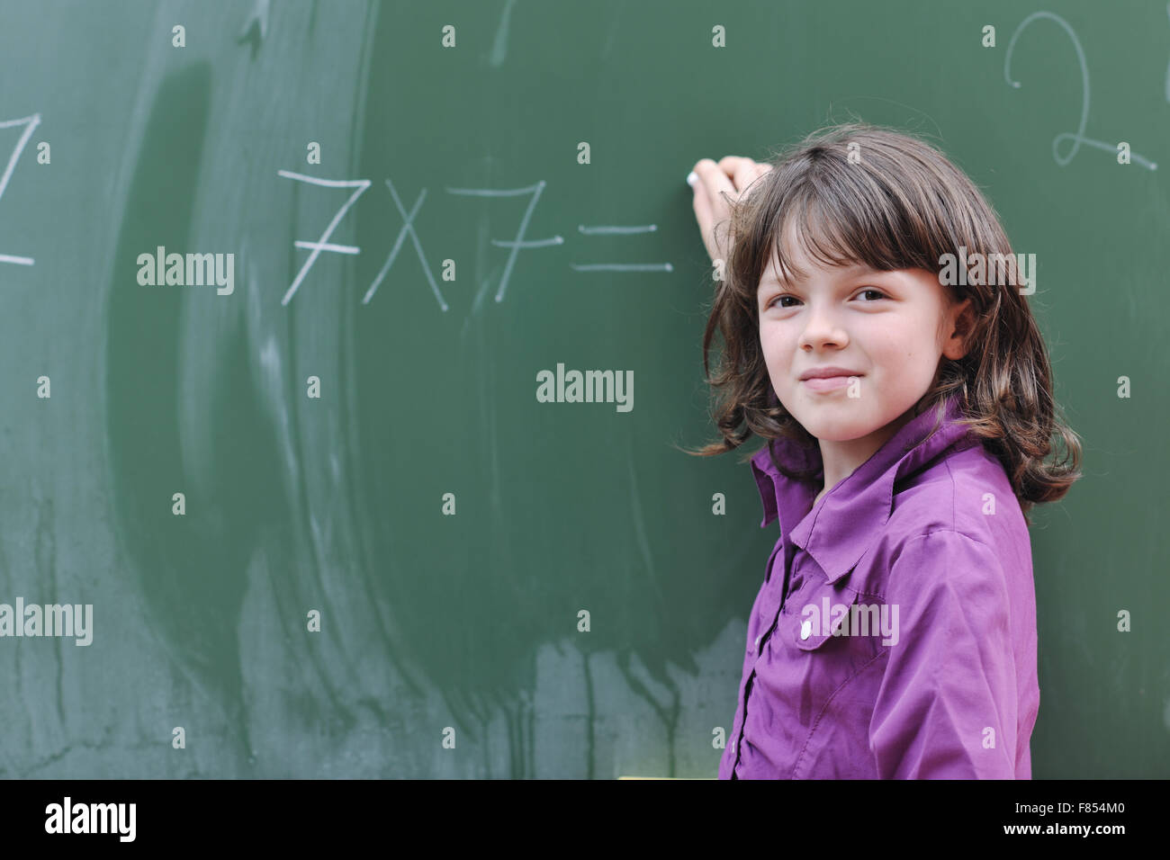 happy school girl on math classes finding solution and solving problems ...