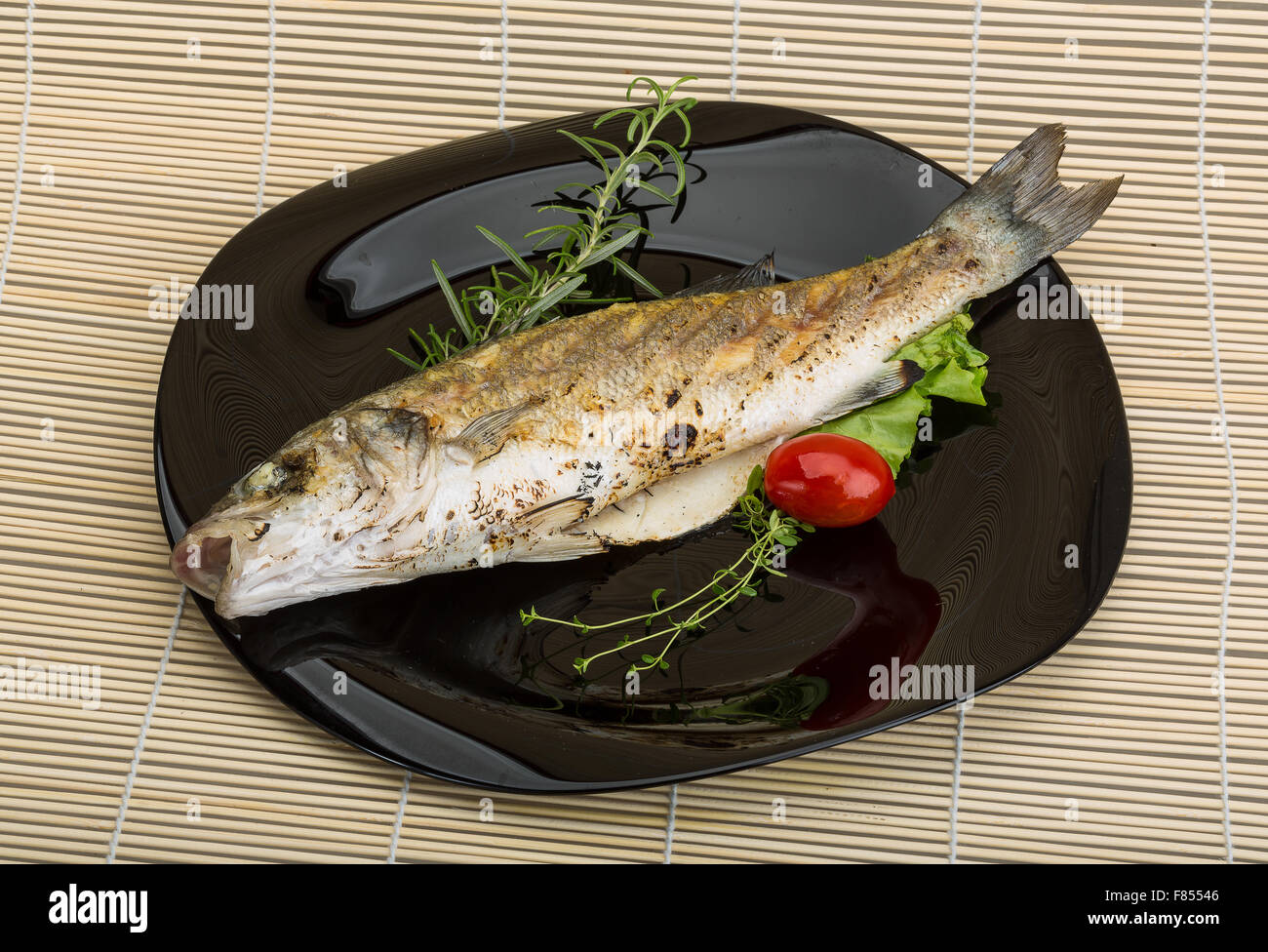 Grilled seabass fish - with rosemary and thyme Stock Photo - Alamy