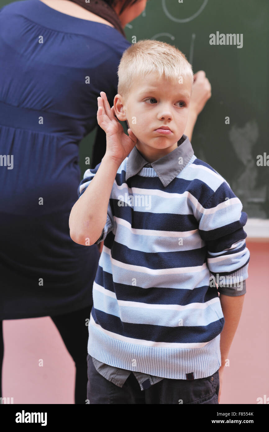 happy young boy at first grade math classes solving problems and ...