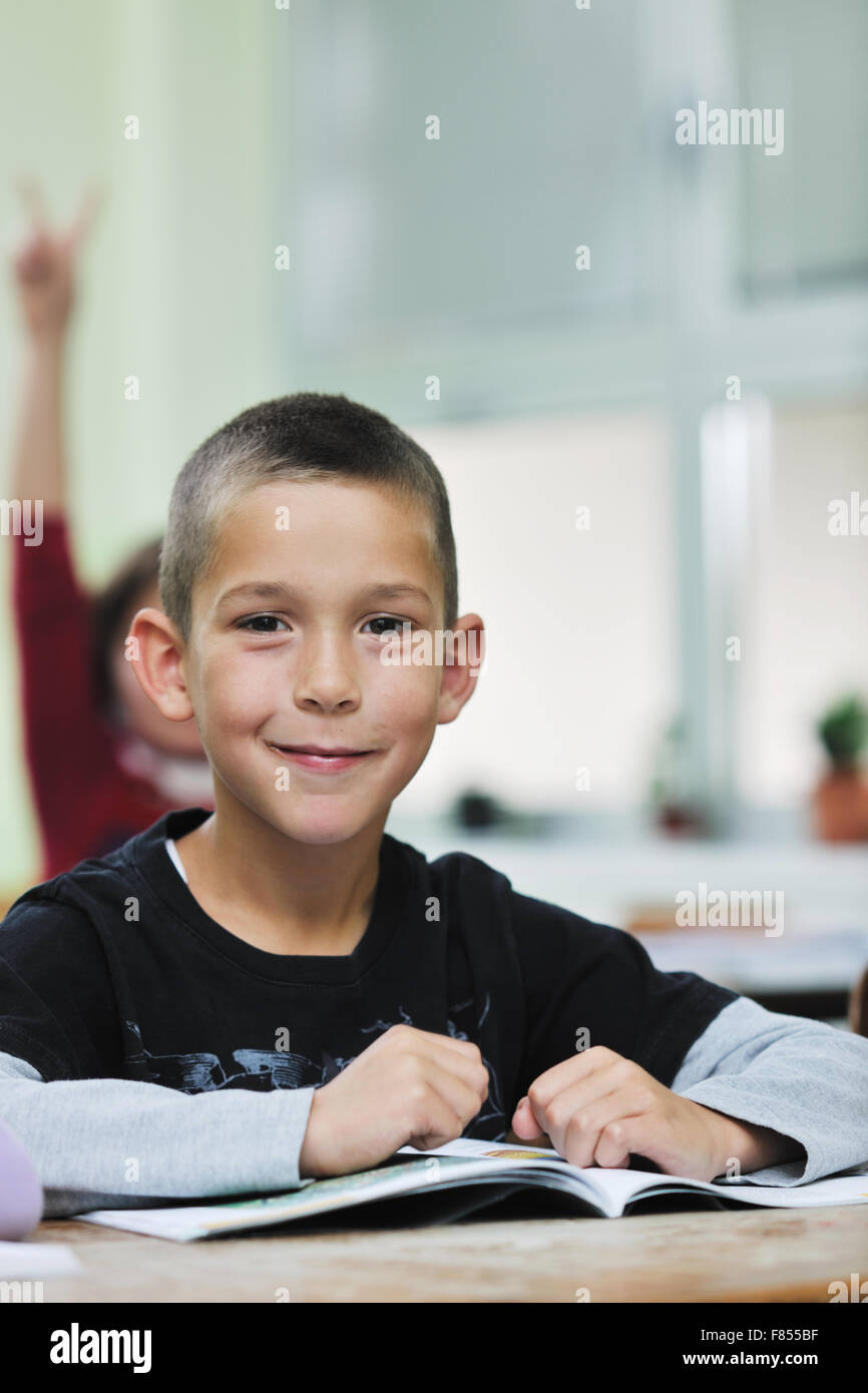 happy young boy at first grade math classes solving problems and ...