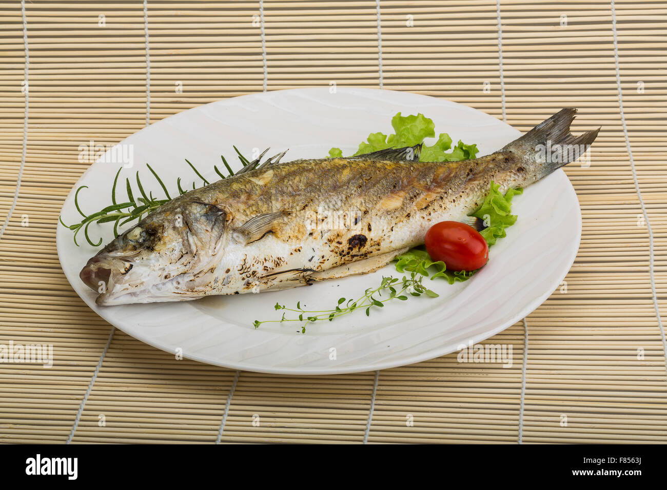 Grilled seabass fish - with rosemary and thyme Stock Photo - Alamy