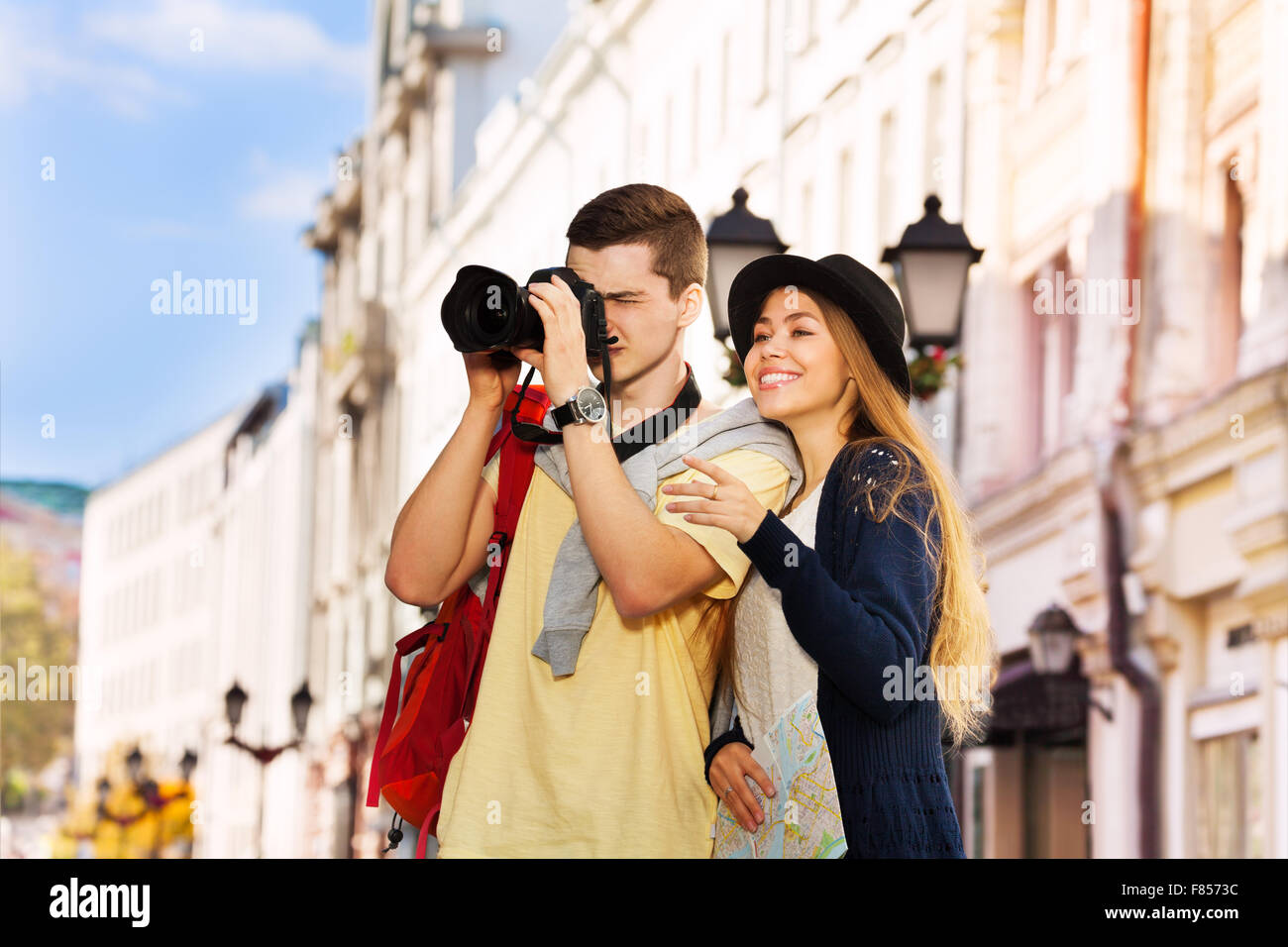 Young man shooting with camera and girl near Stock Photo - Alamy