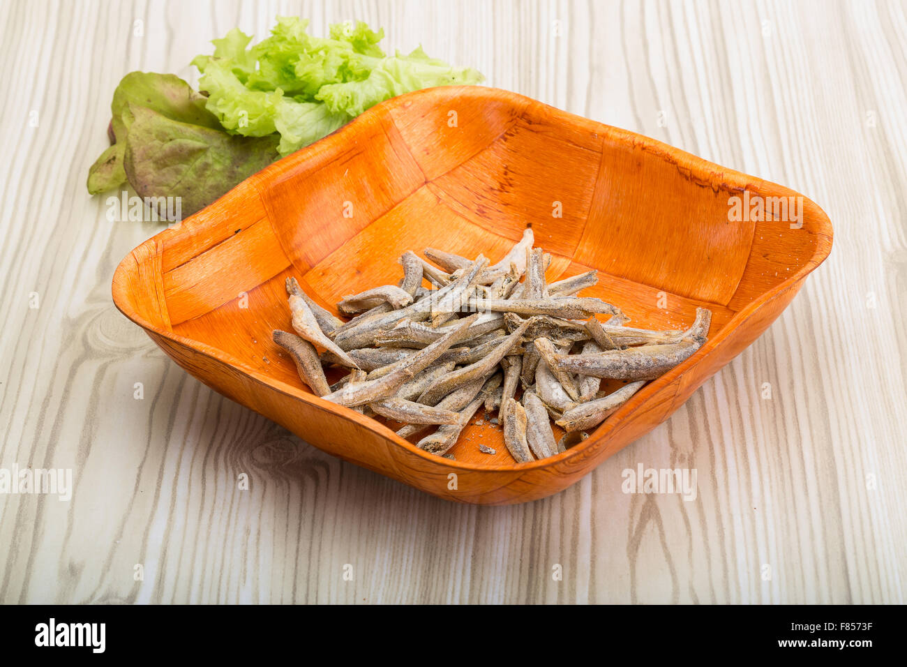 Dries anchovy - small fishes in the bowl Stock Photo - Alamy