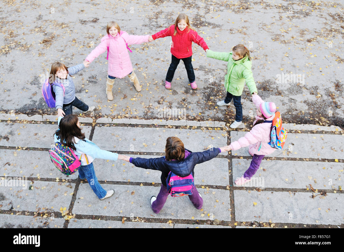 happy young child group outdoor standing together in circle formation ...