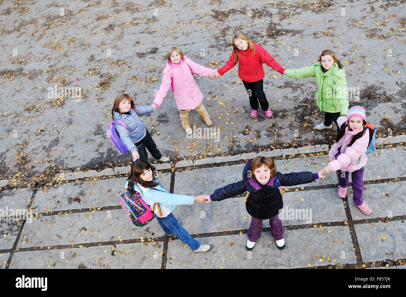 happy young child group outdoor standing together in circle formation ...