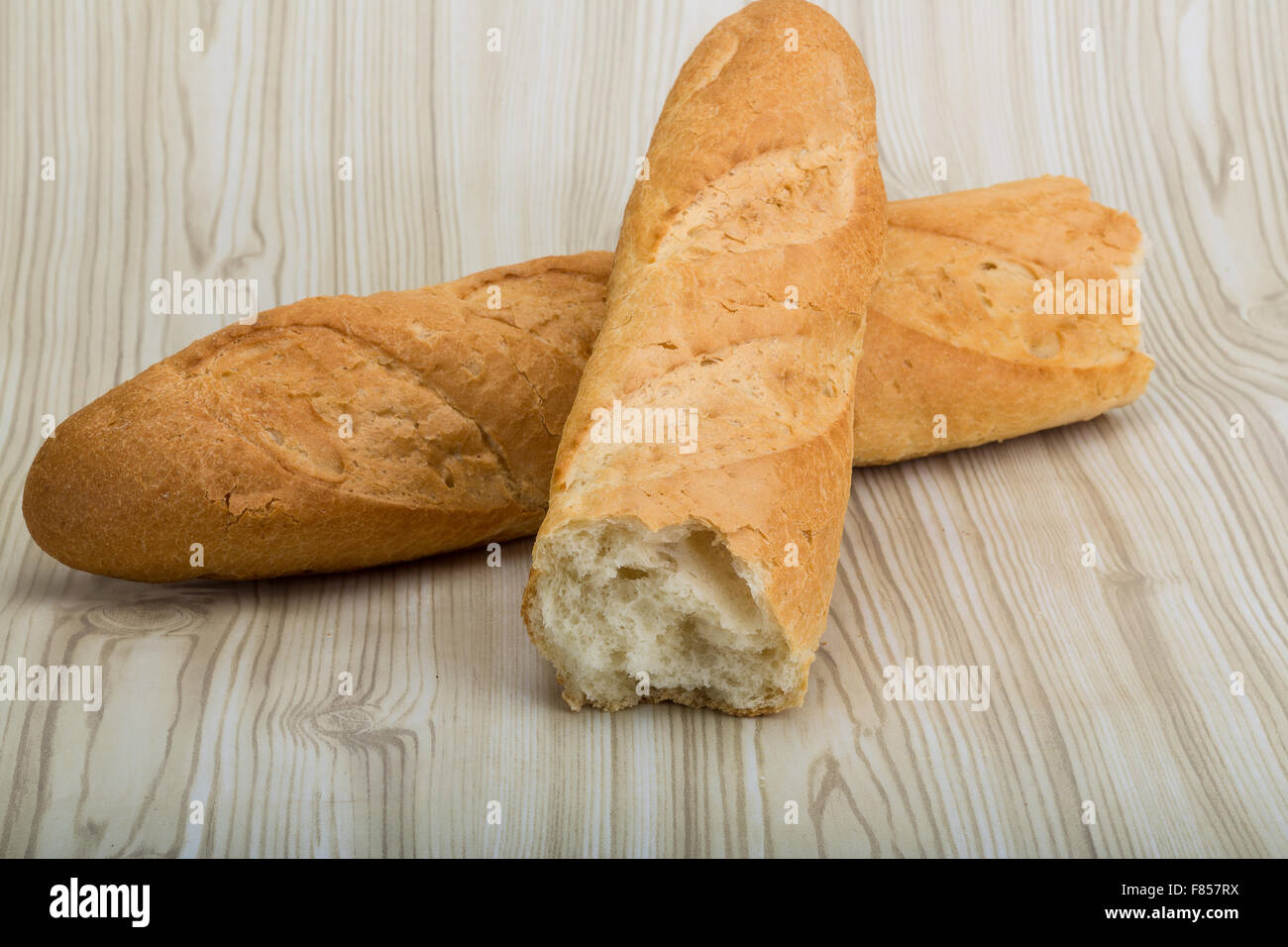 Broken fresh loaf bread on the board Stock Photo - Alamy