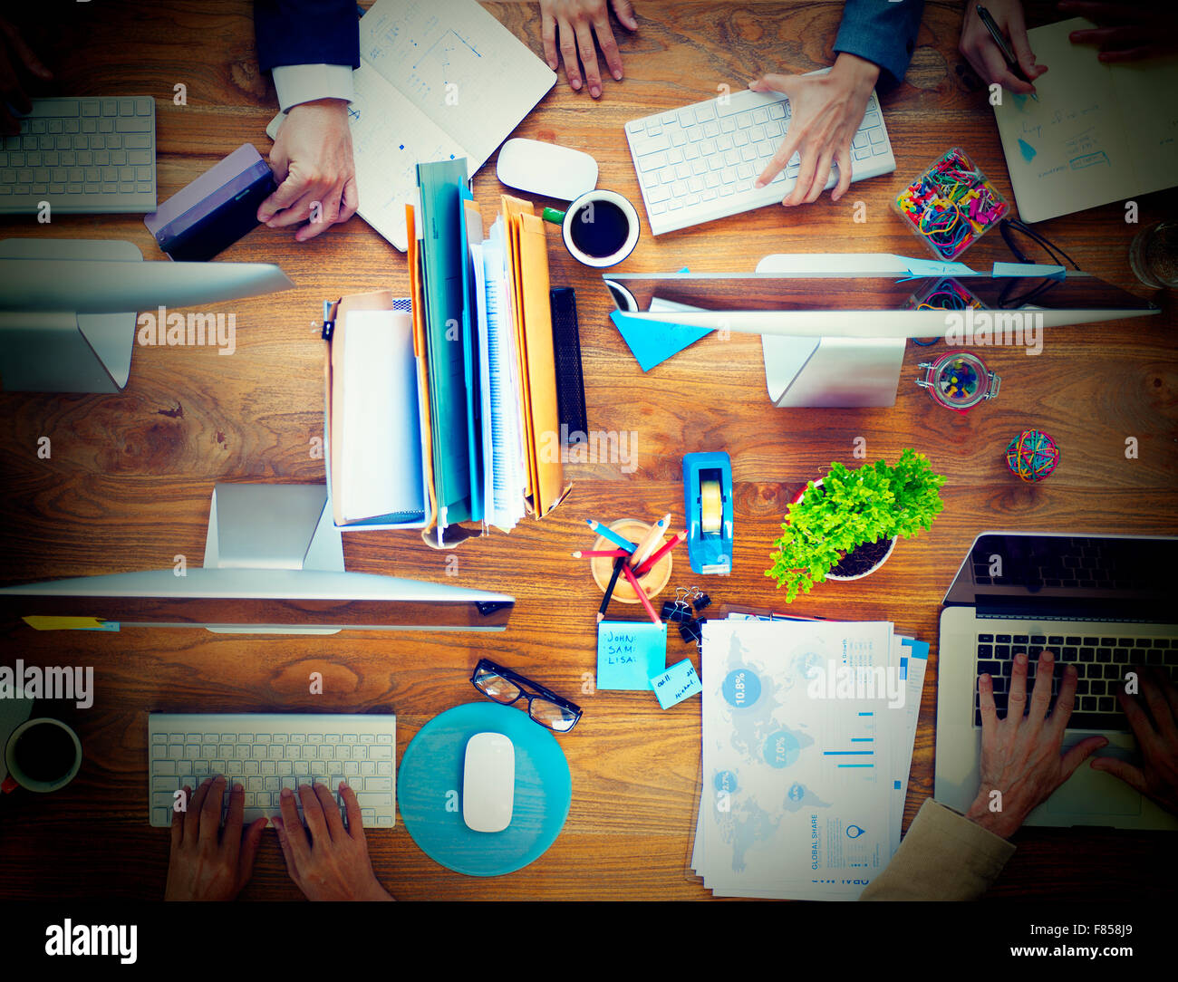 Group of Business People Working on an Office Desk Concept Stock Photo ...