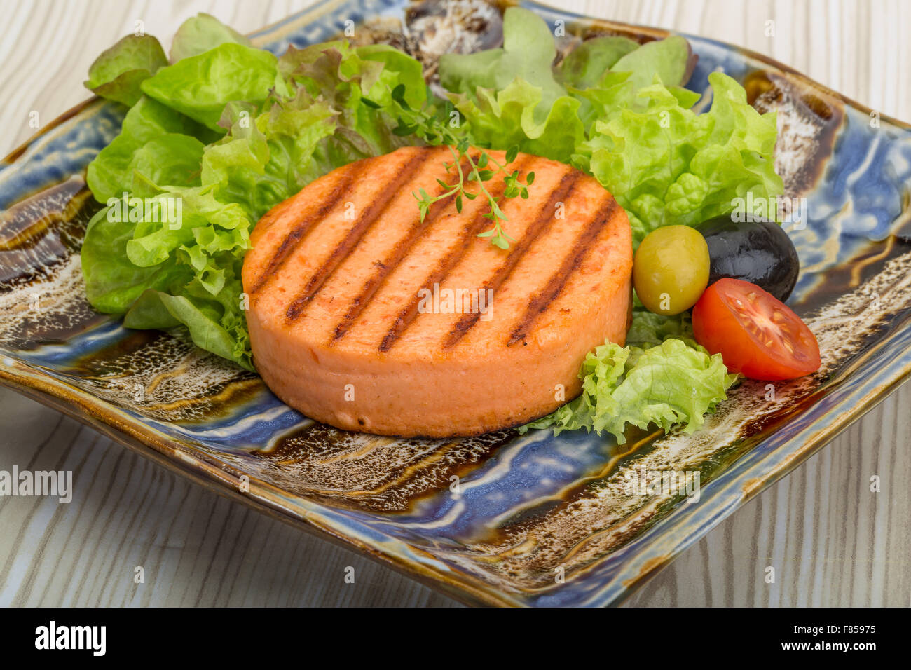 Grilled Fish cakes in the bowl with salad leaves Stock Photo - Alamy