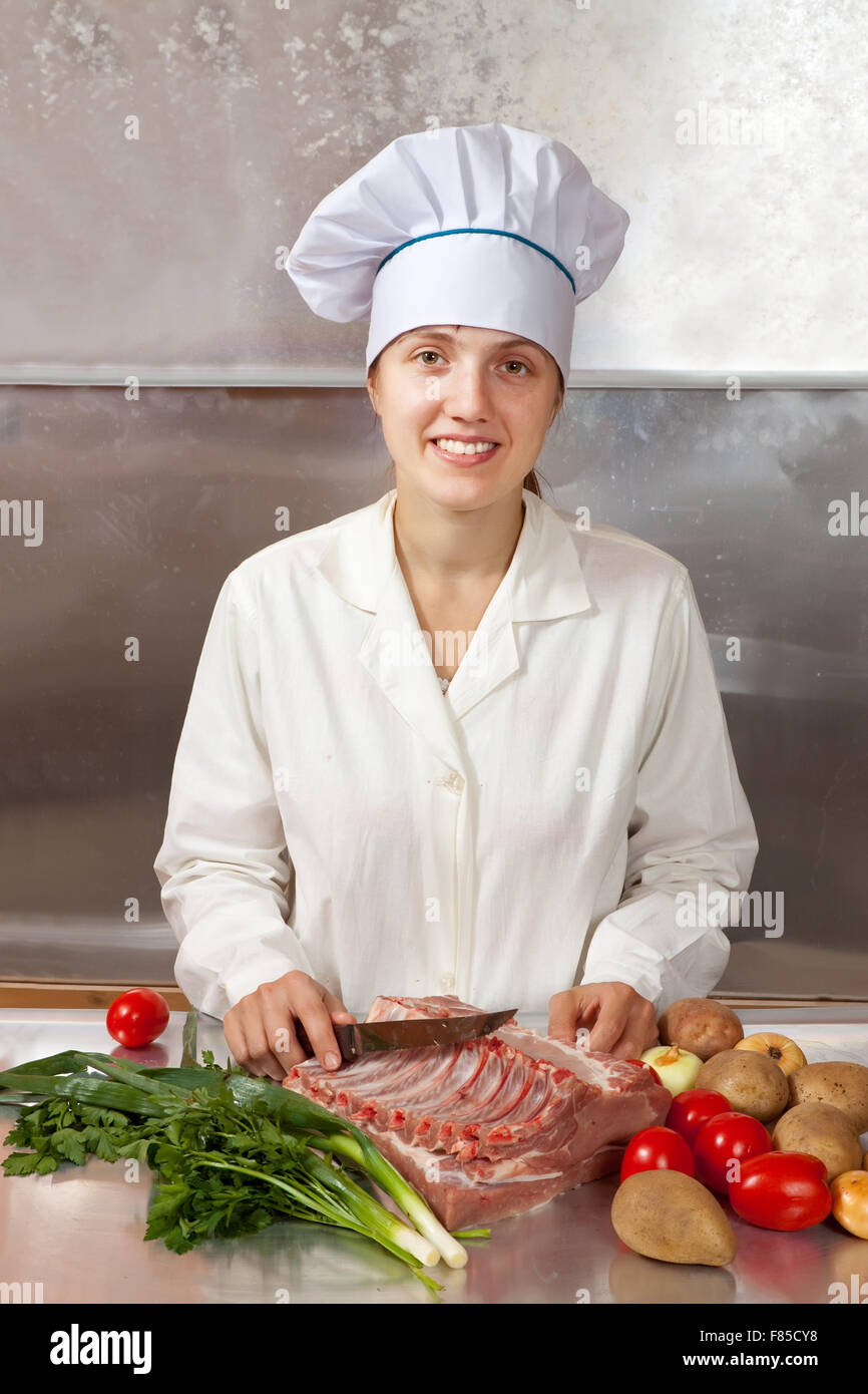 Cook woman cooking meat in kitchen Stock Photo - Alamy