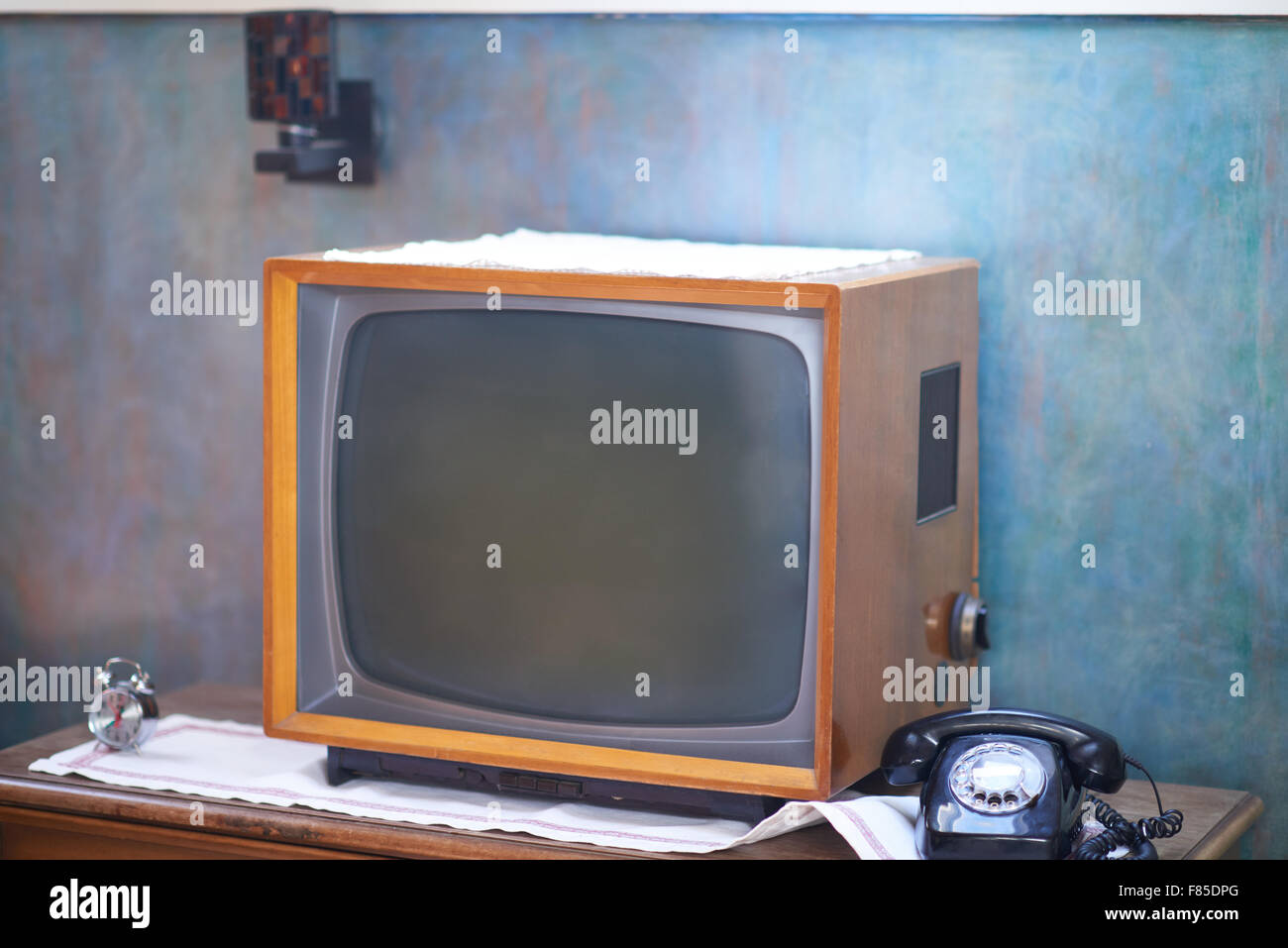 Vintage retro look living room detail. Television, telephone and clock ...