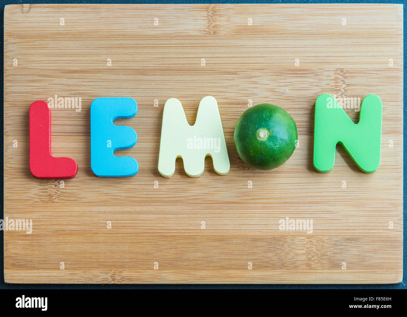 Lemon wooden word on chopping block Stock Photo - Alamy