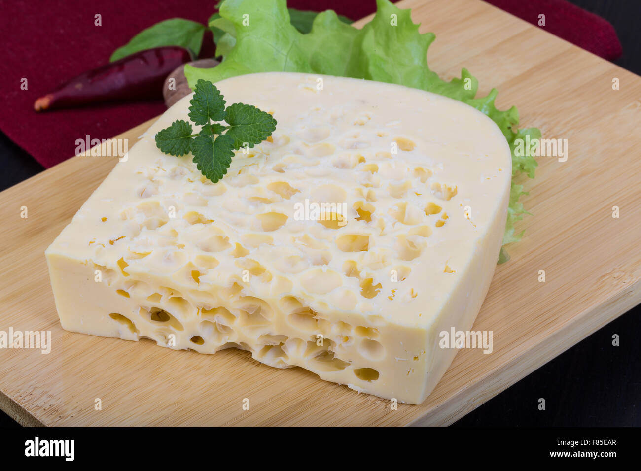 Yellow cheese - maasdam with salad leaves Stock Photo - Alamy
