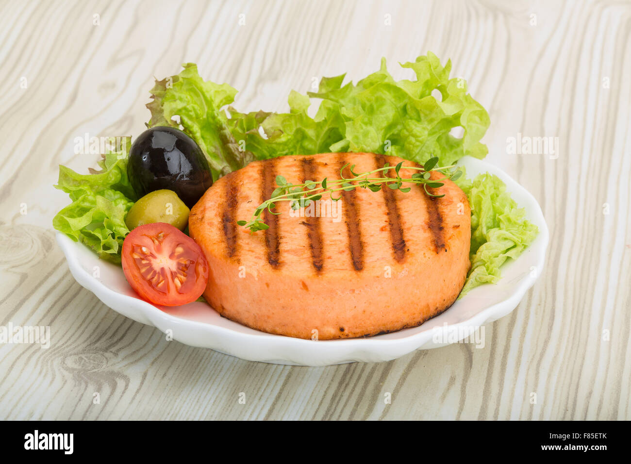 Grilled Fish cakes in the bowl with salad leaves Stock Photo - Alamy