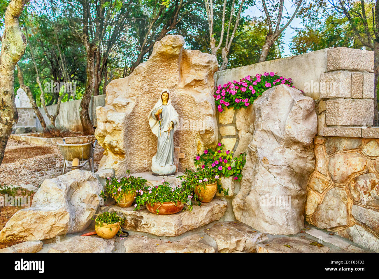 Statue of the Blessed Virgin Mary with Baby Jesus in rock garden in ...