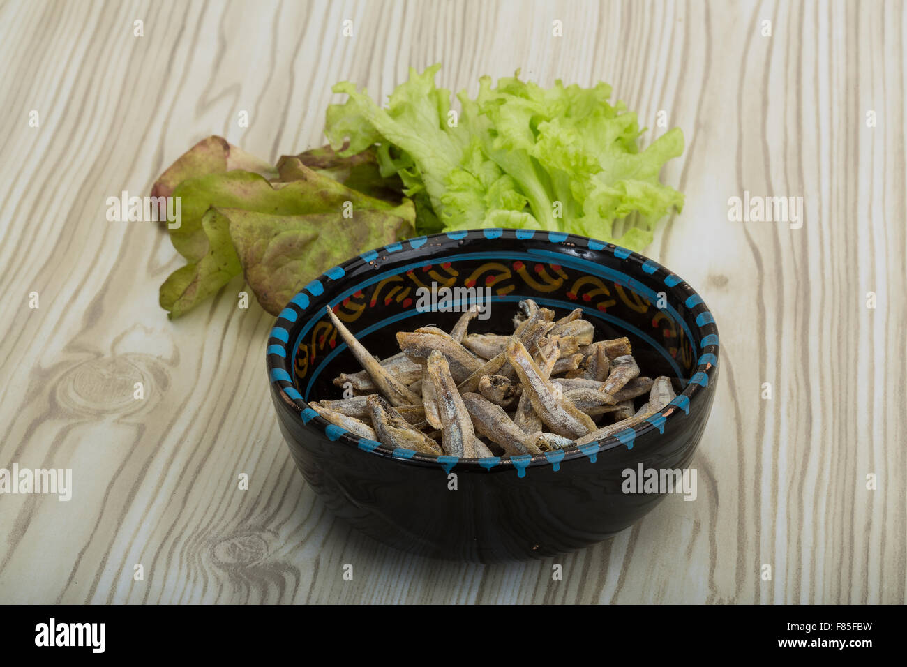 Dries anchovy - small fishes in the bowl Stock Photo - Alamy