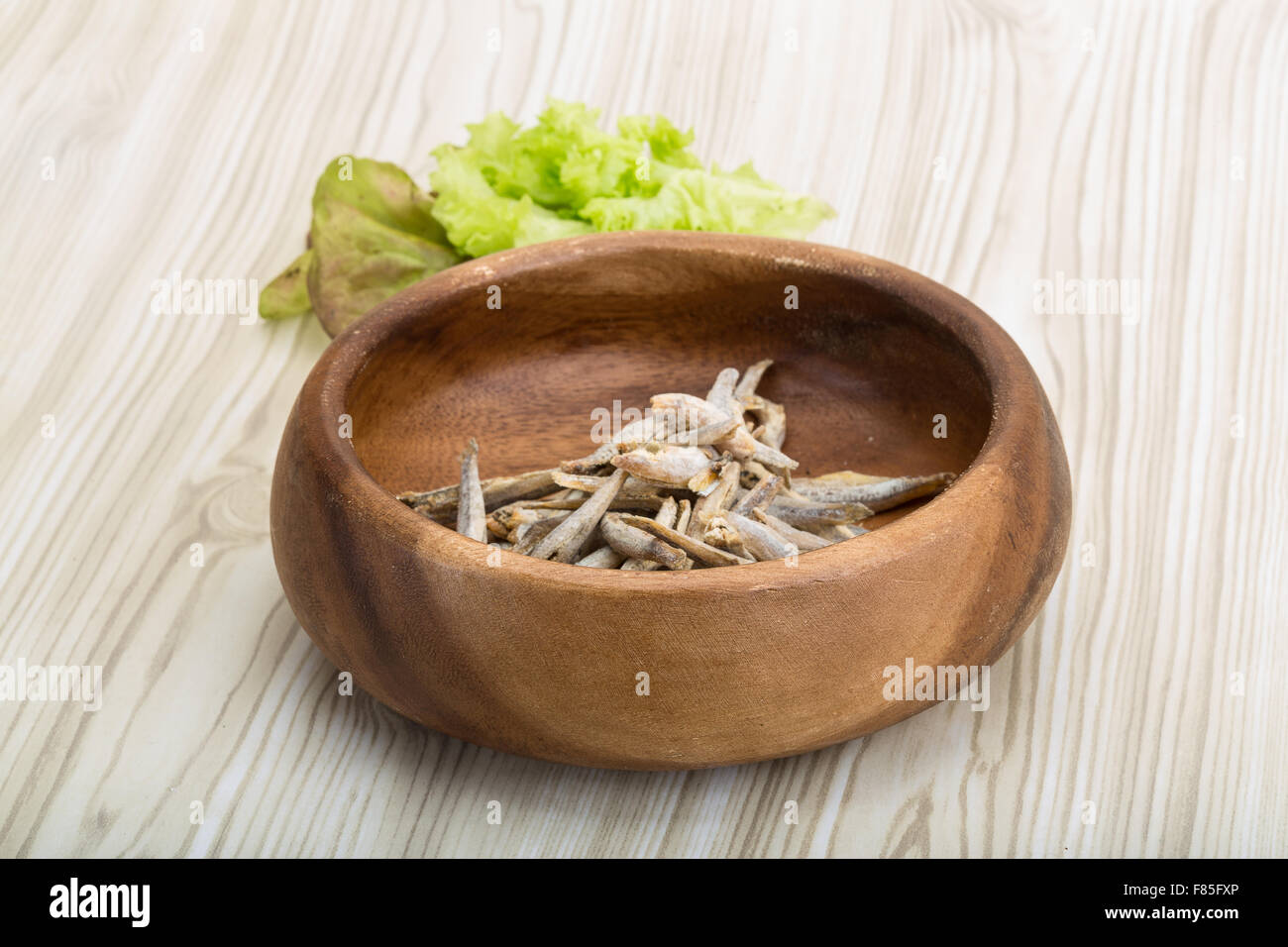 Dries anchovy - small fishes in the bowl Stock Photo - Alamy