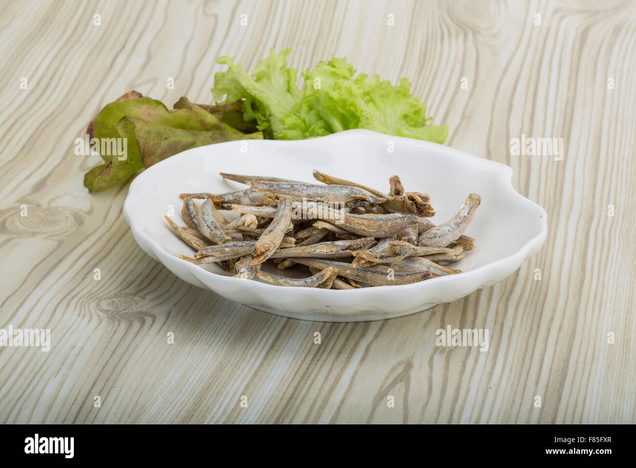 Dries anchovy - small fishes in the bowl Stock Photo - Alamy