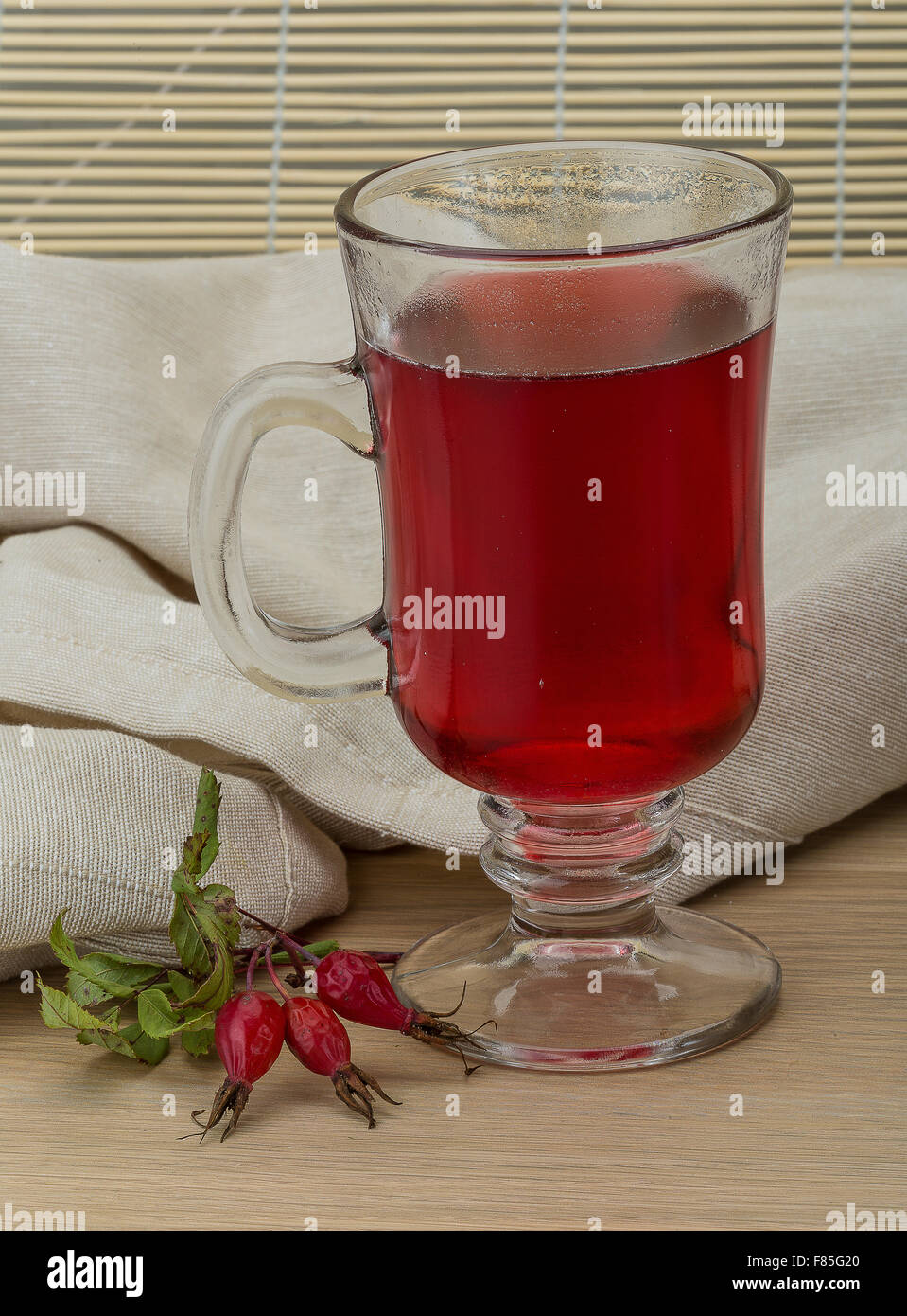Hot hip tea with berries on the wood background Stock Photo - Alamy