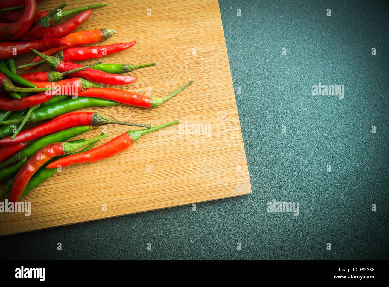 Green chilli pepper and Red chilli pepper on chopping block 4 Stock ...