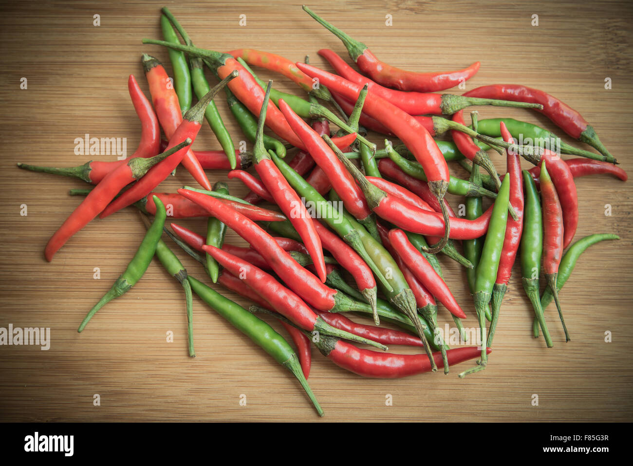 Red and Green chilli pepper on chopping block 2 Stock Photo - Alamy